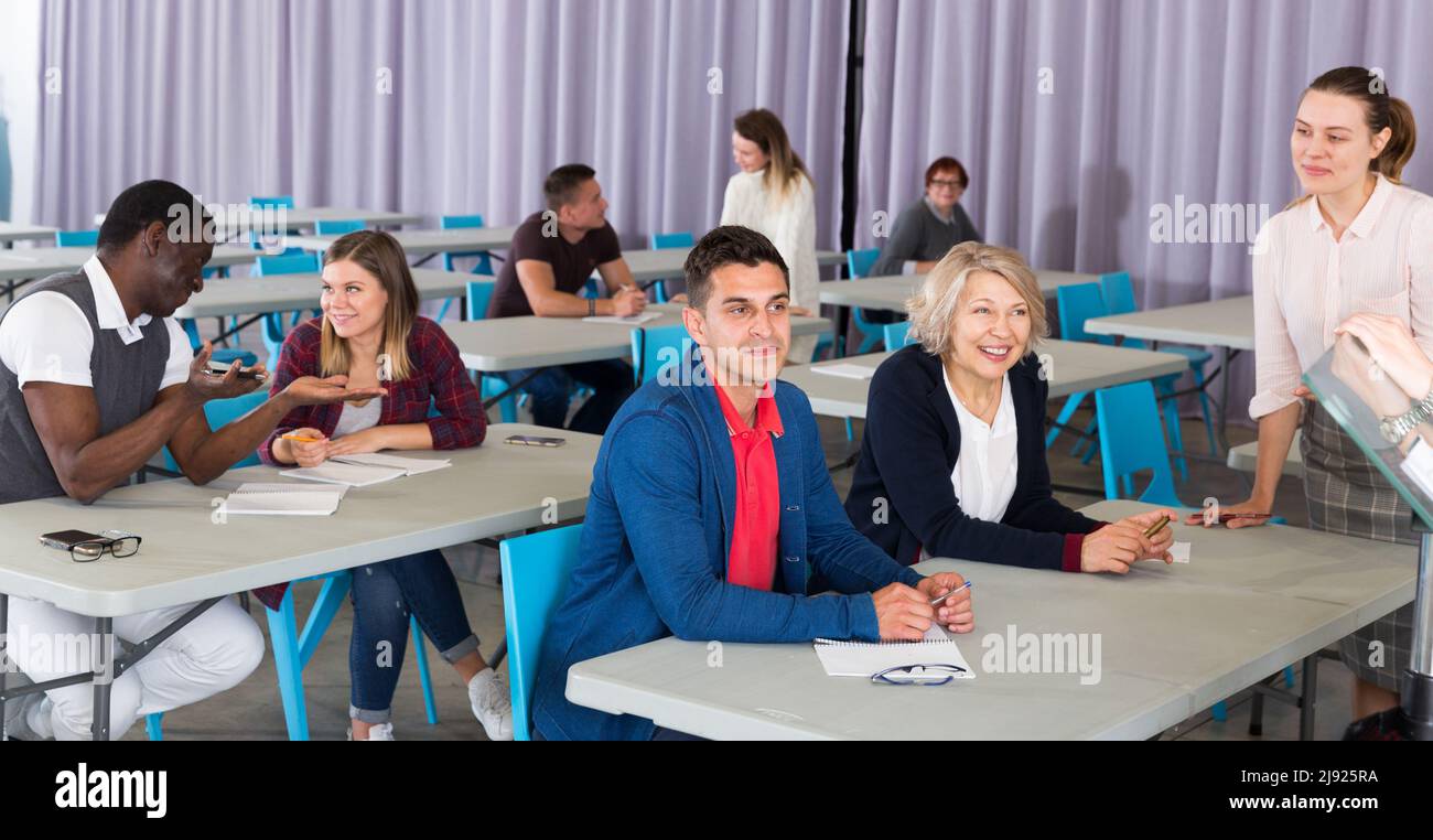 Adult people communicating in classroom Stock Photo - Alamy