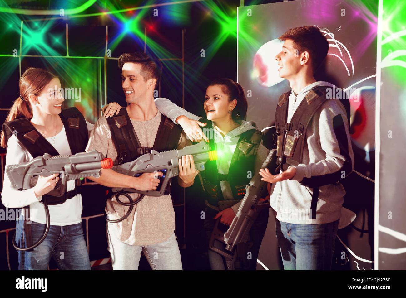 Triumphing team of laser tag winners guys and girls Stock Photo - Alamy