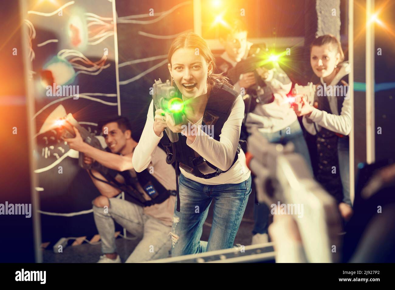 Smiling girl with laser guns took aim and having fun with friends Stock ...