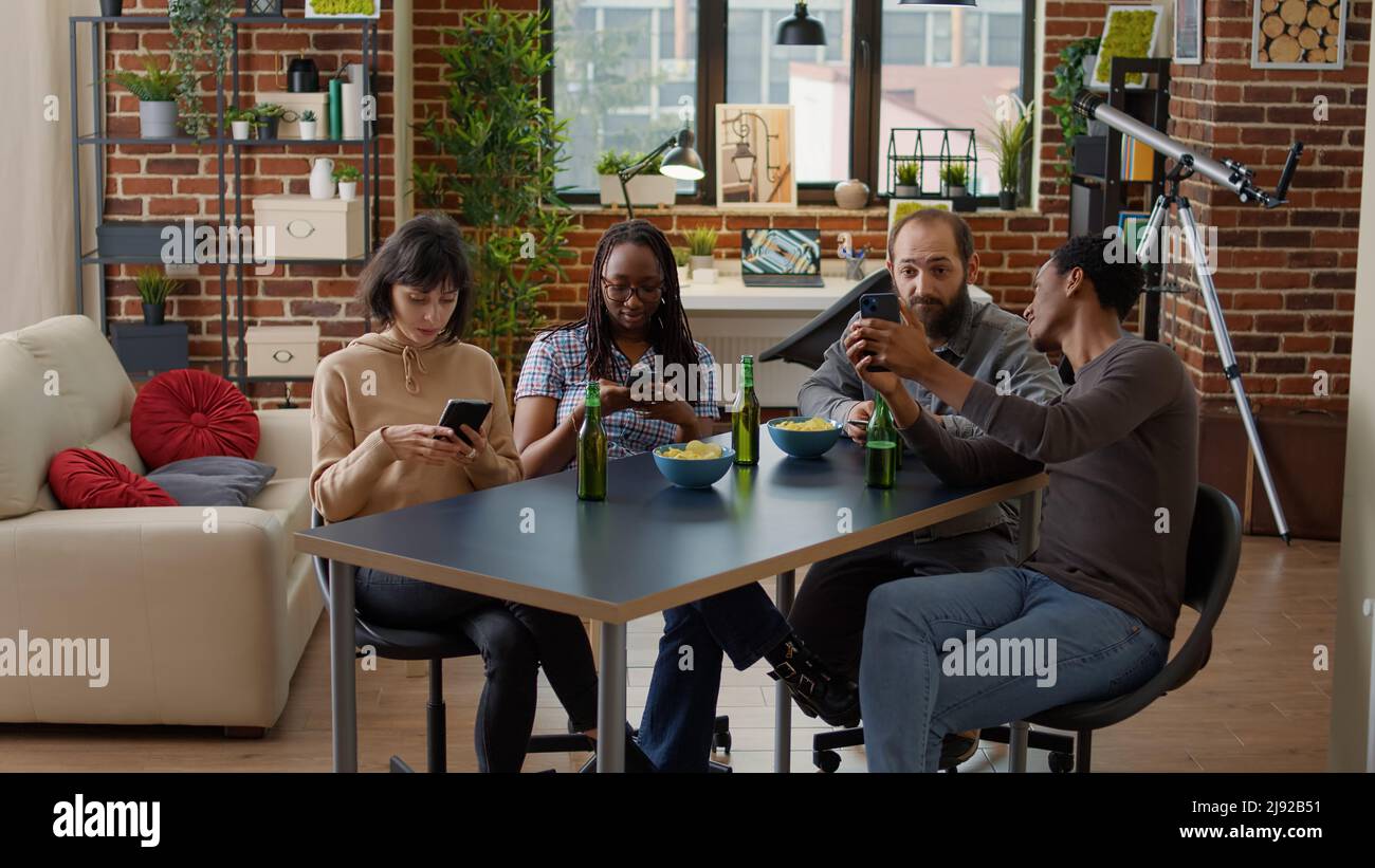 Millennial people hanging out together and browsing internet on ...