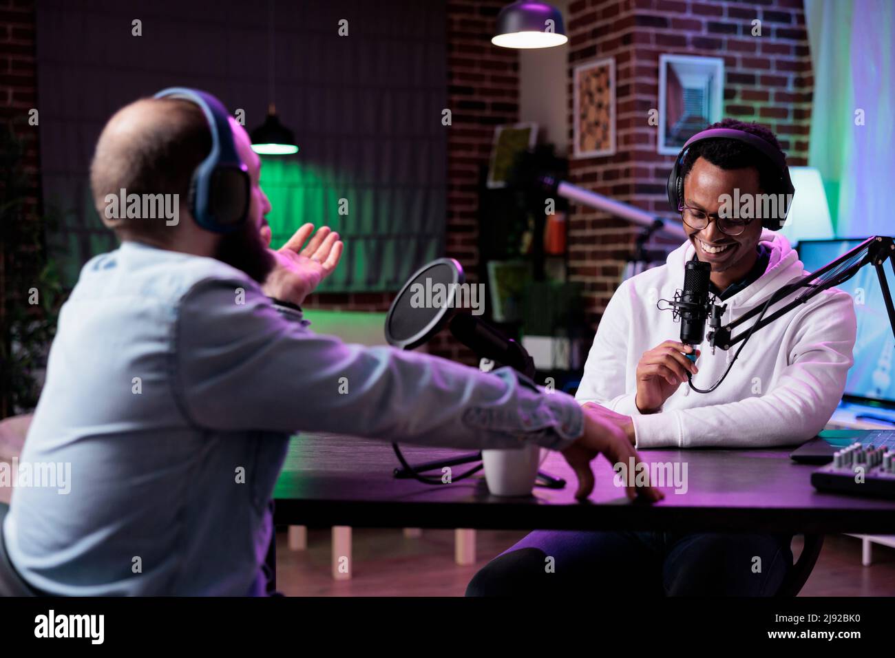 Podcast host having live conversation with person, recording discussion ...