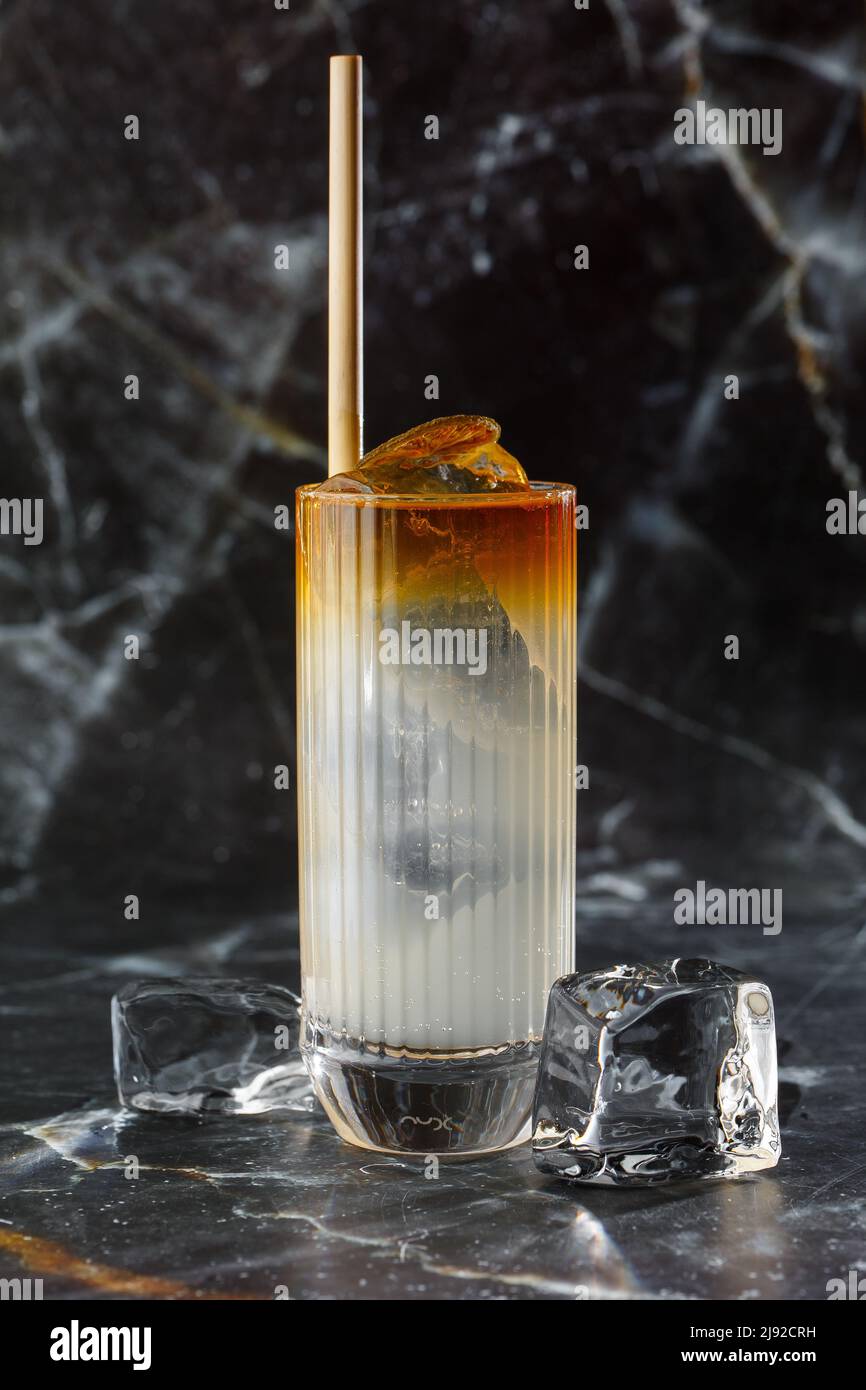 Dark n Stormy cocktail standing on the black marble background ...