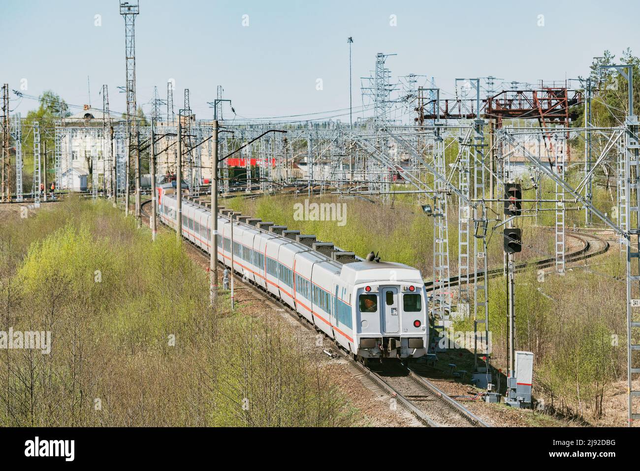 Passenger train approaches to the station Stock Photo - Alamy