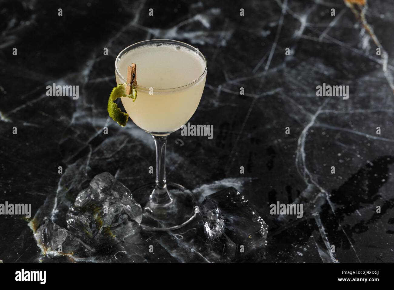 Gimlet Kamikaze cocktail in martini glass with ice on black marble ...
