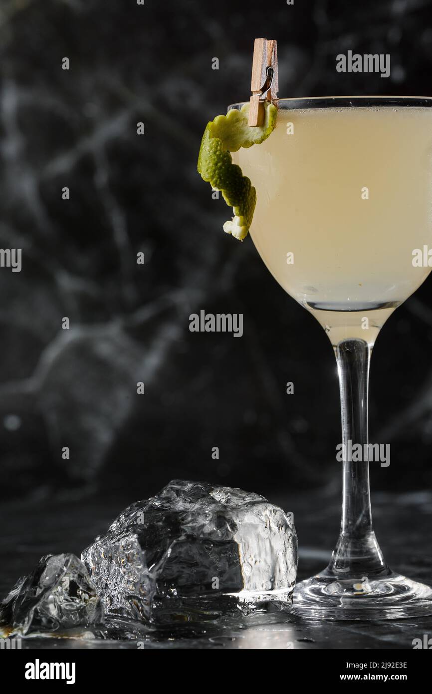 Gimlet Kamikaze cocktail in martini glass with ice on black marble ...