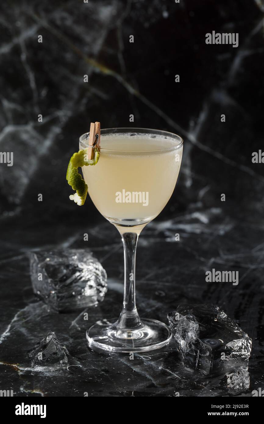 Gimlet Kamikaze cocktail in martini glass with ice on black marble ...