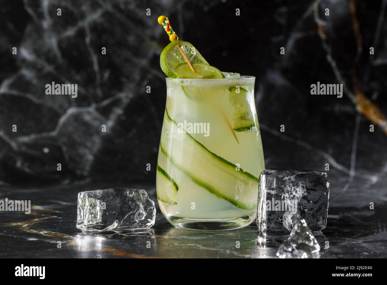 Gin gimlet cocktail garnished with cucumber. Green alcohol cocktail ...