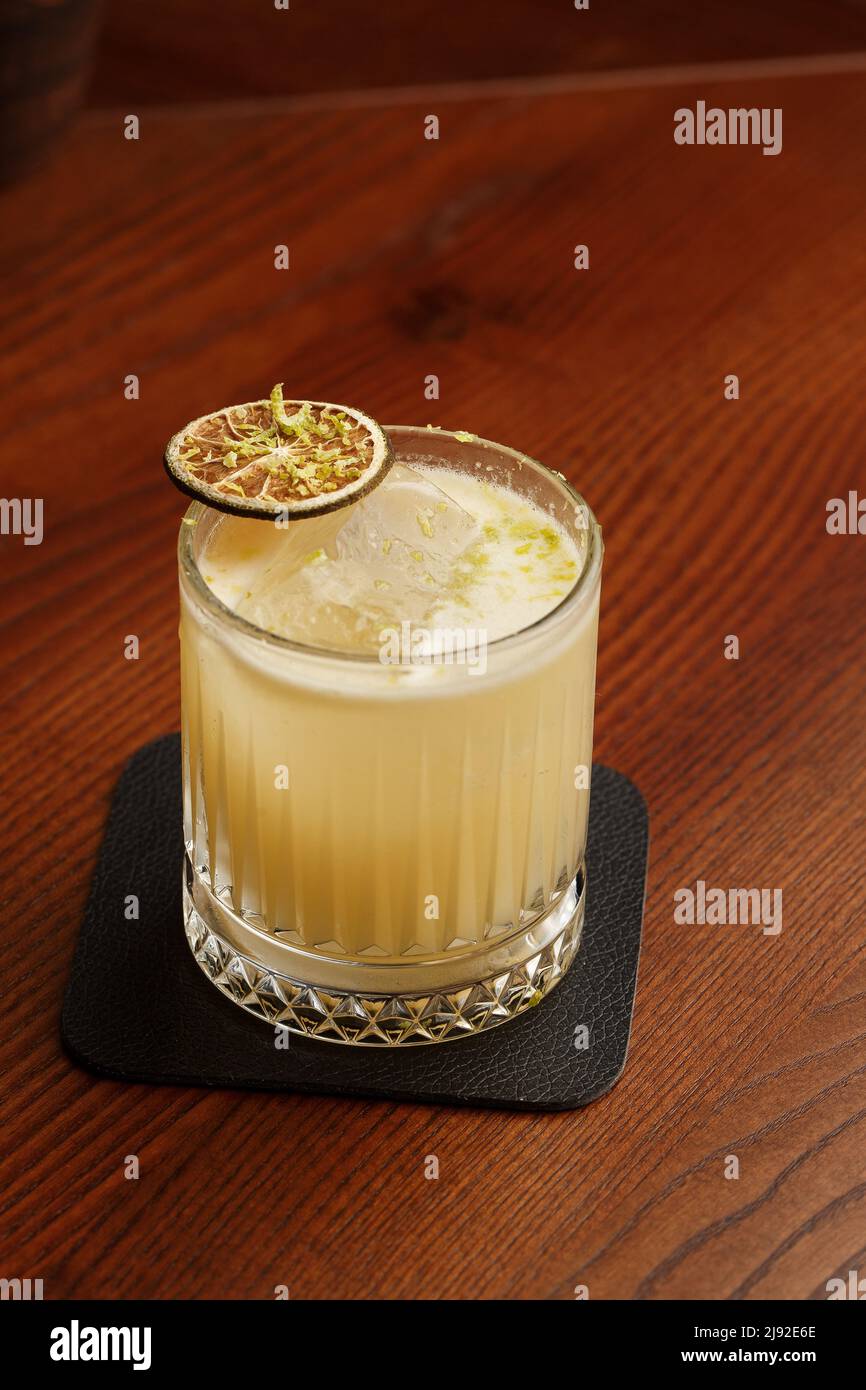 Fruit mixology with mezcal and dry lime on wooden table topper. Warm ...