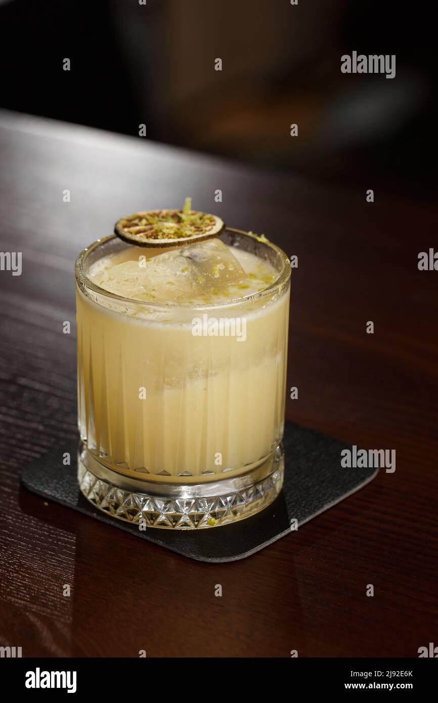 Fruit mixology with mezcal and dry lime on wooden table topper. Warm ...