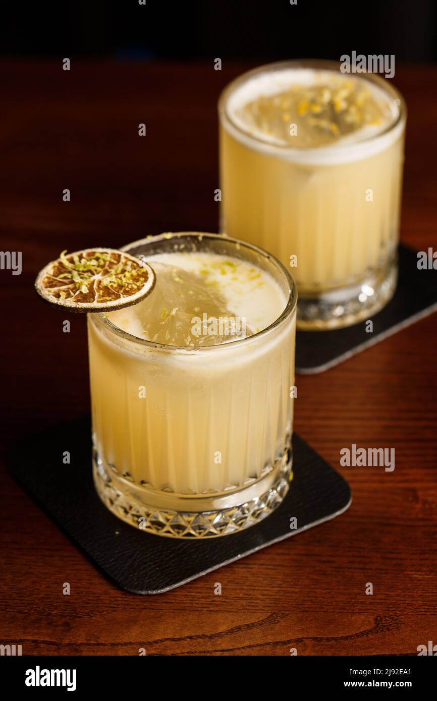 Warm colored cocktails. Mezcal cocktail and Alcoholic Scotch Whiskey ...