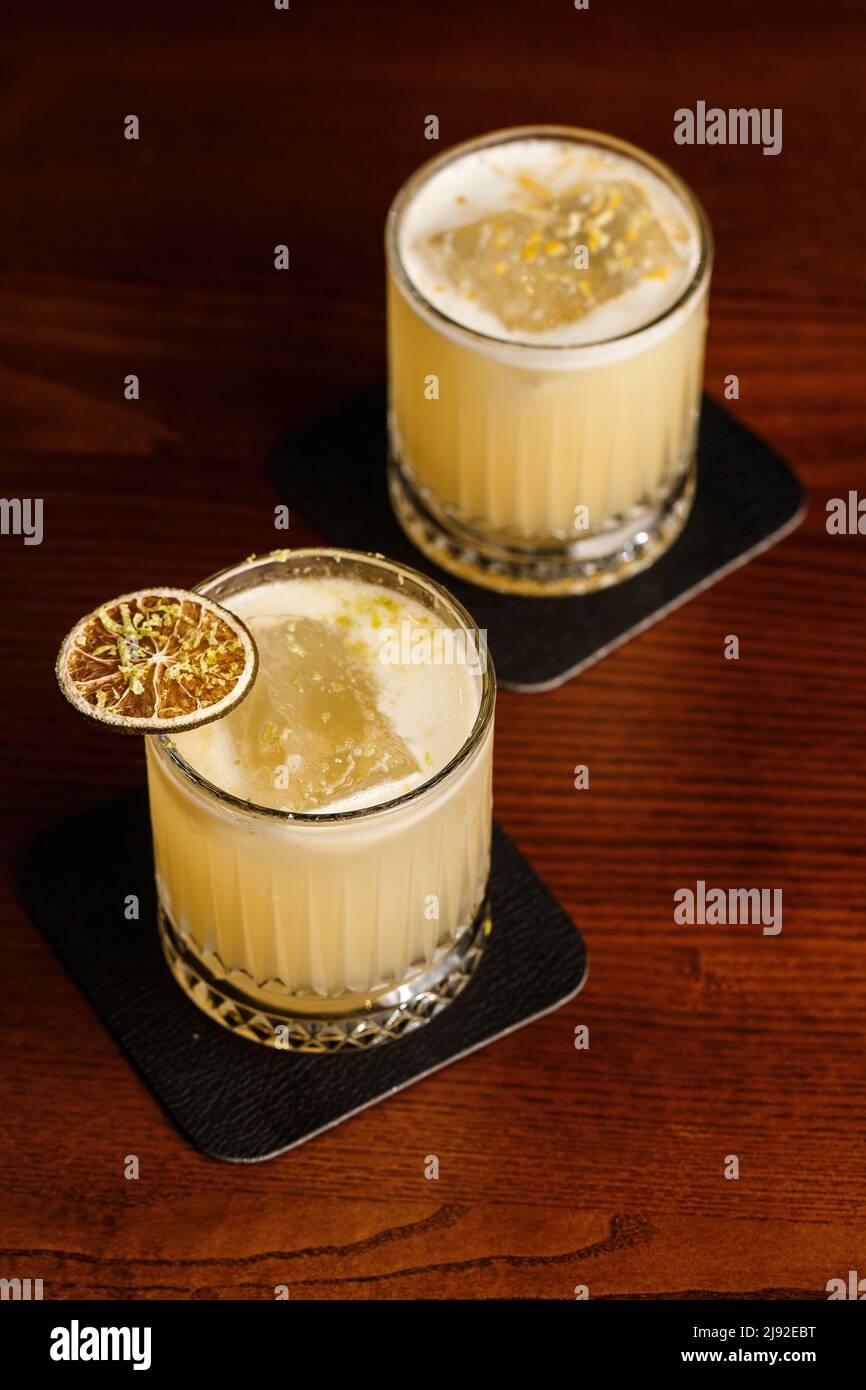 Warm colored cocktails. Mezcal cocktail and Alcoholic Scotch Whiskey ...