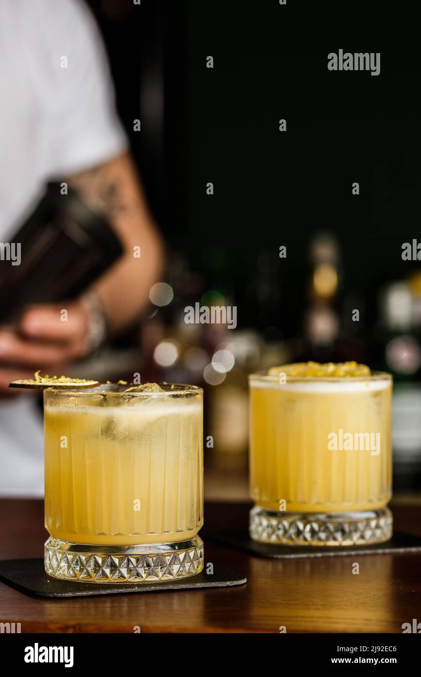 Warm colored cocktails. Mezcal cocktail and Alcoholic Scotch Whiskey ...