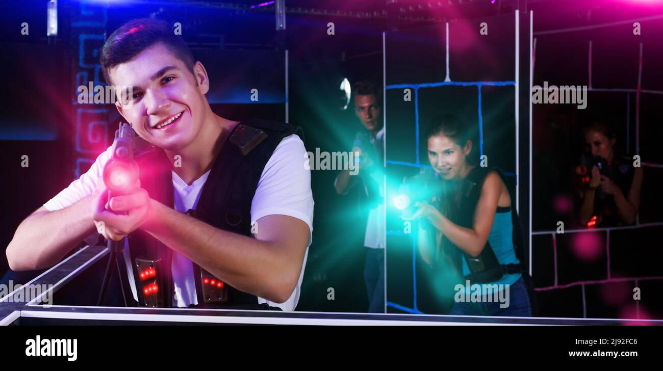 guy holding laser pistol playing laser tag game Stock Photo - Alamy