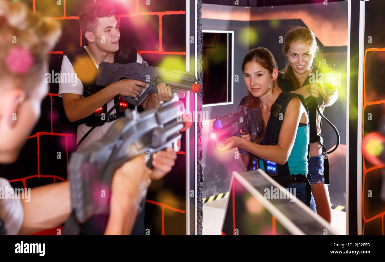 Friendly Laser tag players playing in teams Stock Photo - Alamy