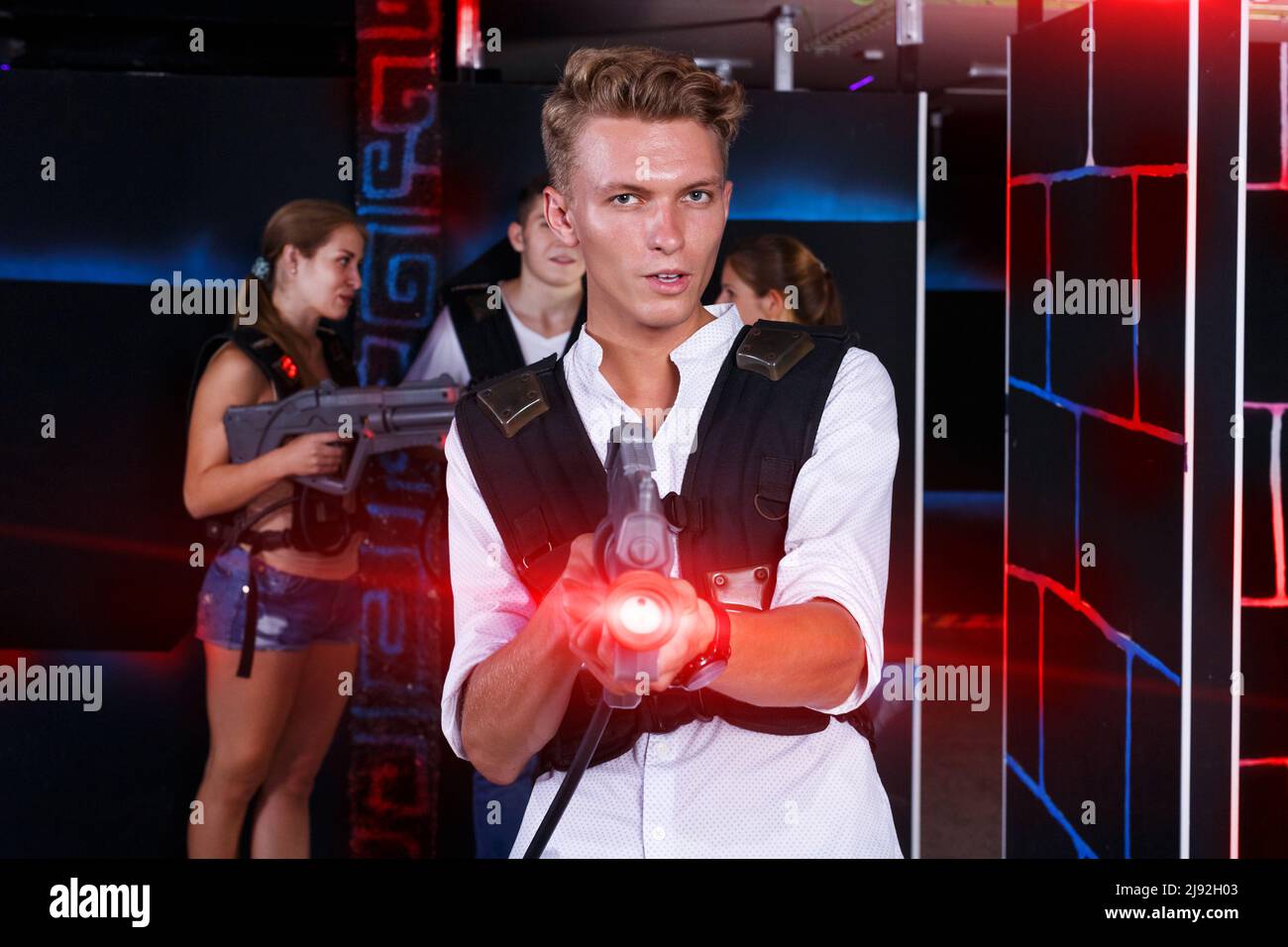 guy holding laser pistol playing laser tag game Stock Photo - Alamy