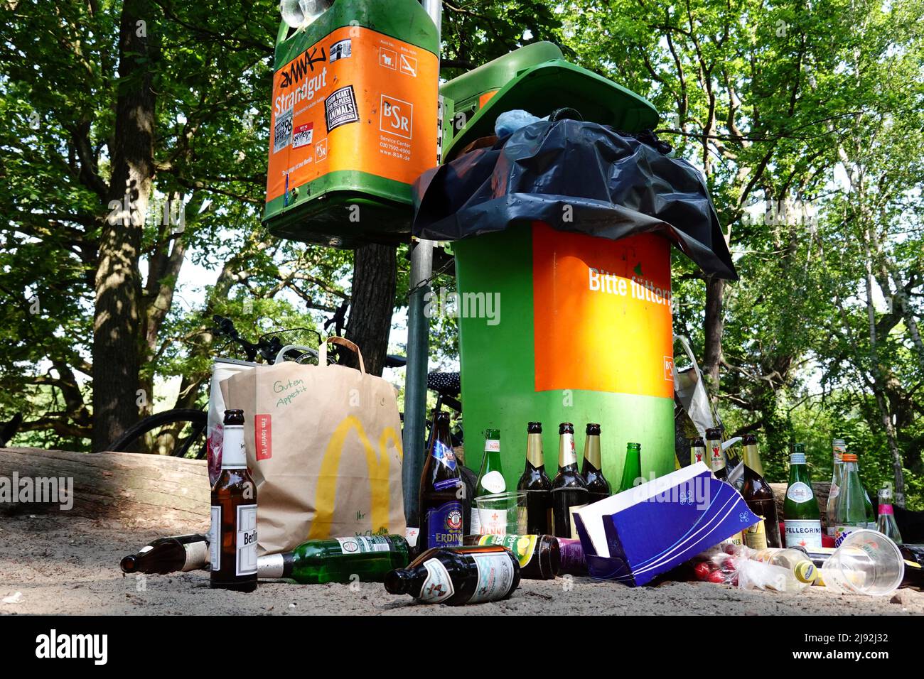 06.06.2021, Berlin, , Germany - Overfilled trash cans in a park ...