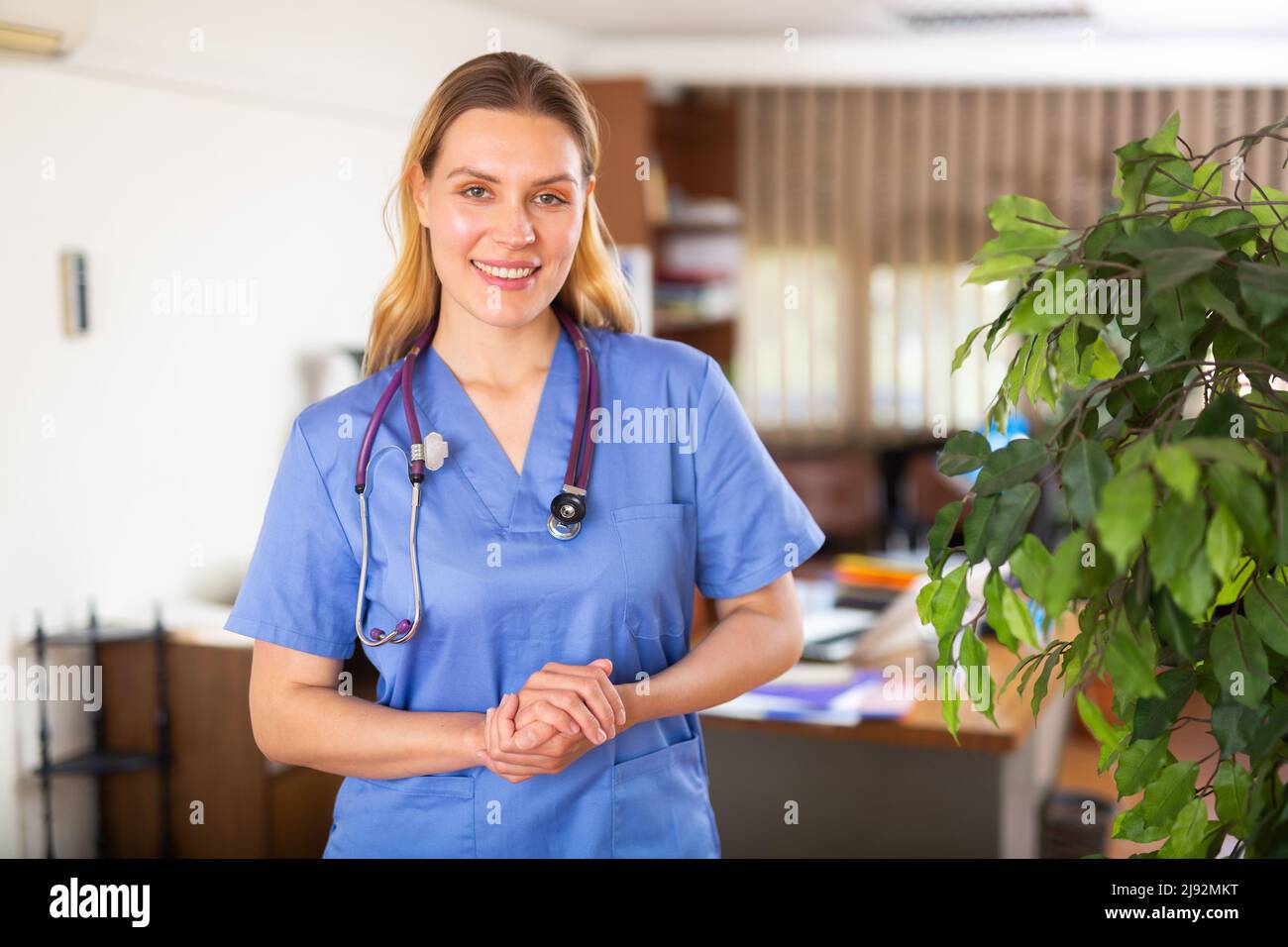 Female doctor assistant standing in medical office Stock Photo - Alamy