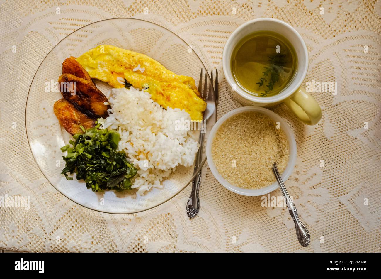 A breakfast made of fried plantains, fried egg roll, steamed amaranth ...
