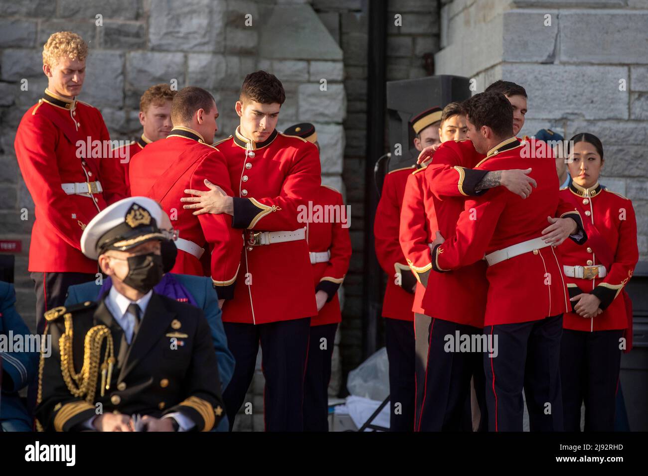 Classmates of the four fallen officer cadet embrace during a ...