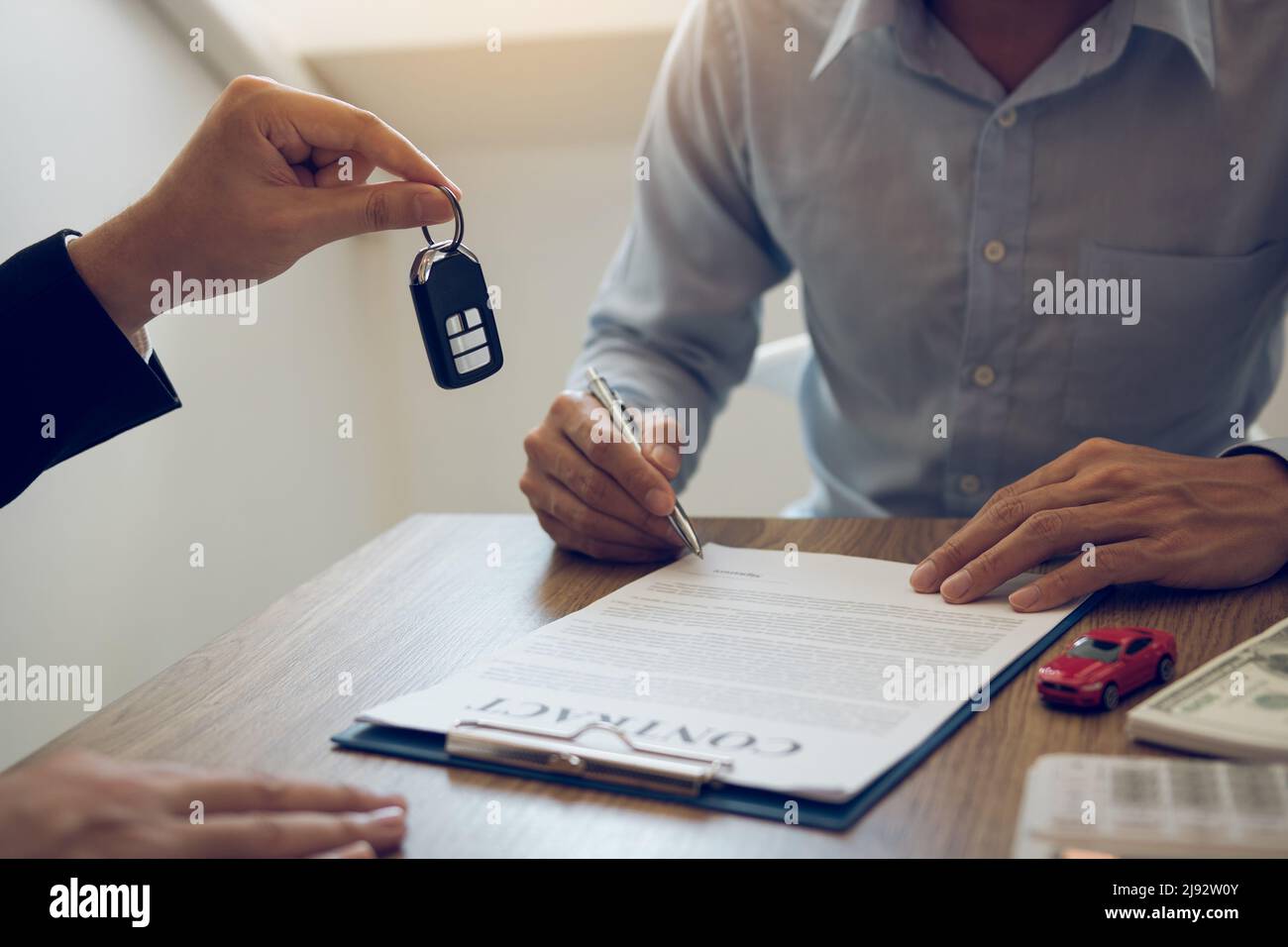 New car buyers sign contract documents for new car purchases at the ...