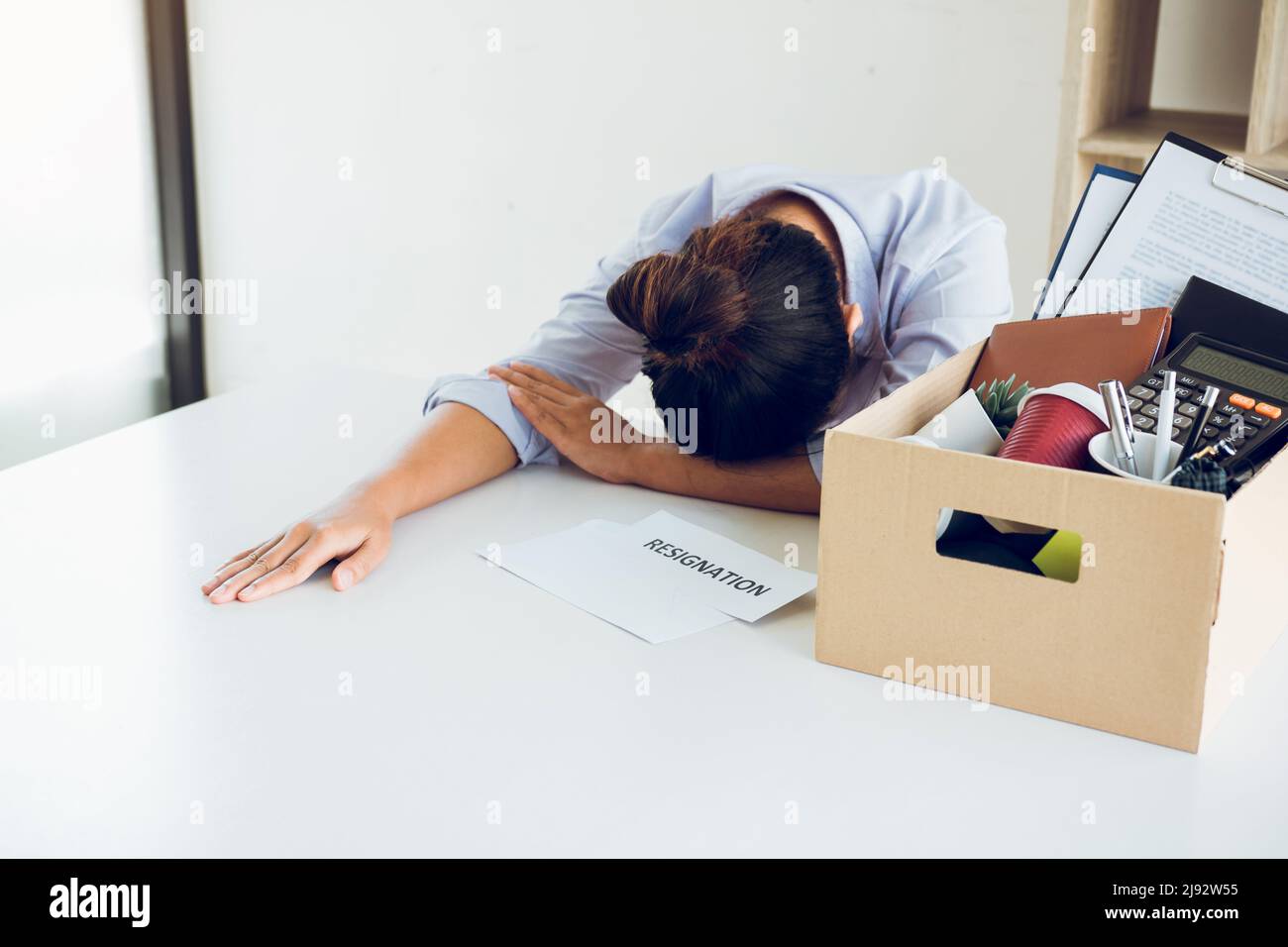 Woman employee feeling sad at his desk when he received the contract ...