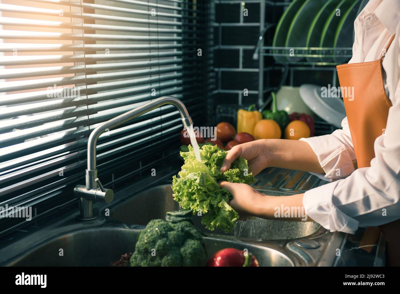 Asian hands woman washing vegetables salad and preparation healthy food ...