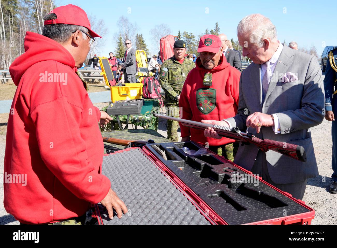 Prince Charles, right, examines a C19 bolt action rifle during a review ...