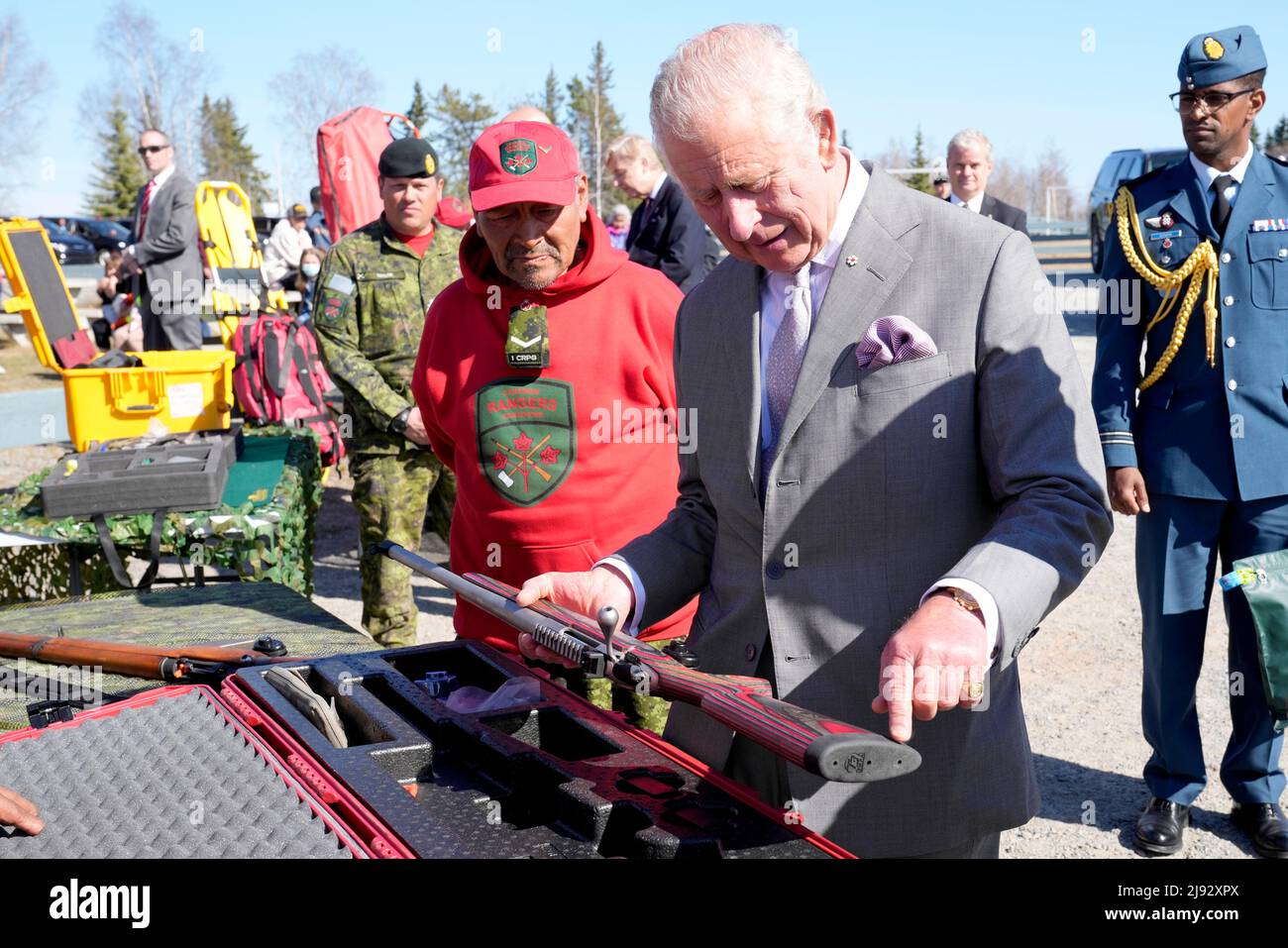 Prince Charles, right, examines a C19 bolt action rifle during a review ...