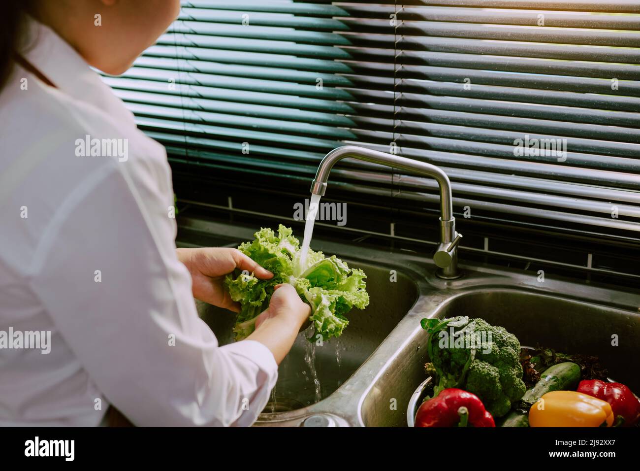 Asian hands woman washing vegetables salad and preparation healthy food ...