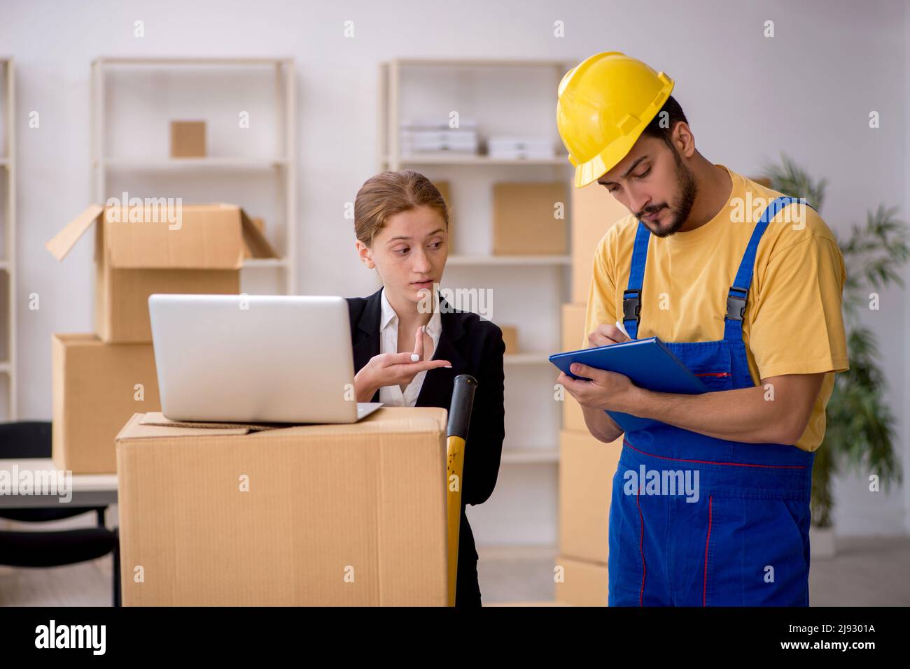 Female boss and male contractor doing home relocation Stock Photo - Alamy