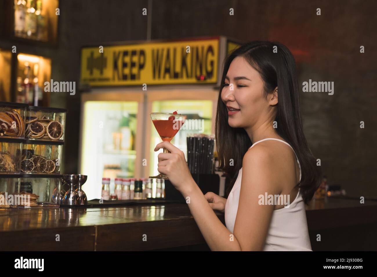 Asian women drinking cocktails and having fun at the bar at night Stock ...