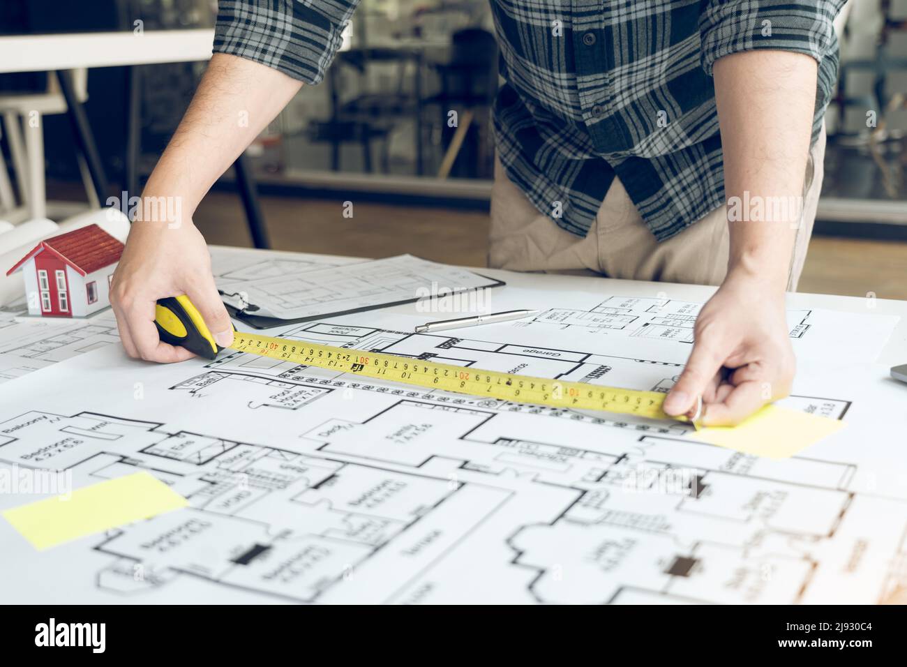 Architects are working on a new project while using a tape measure ...