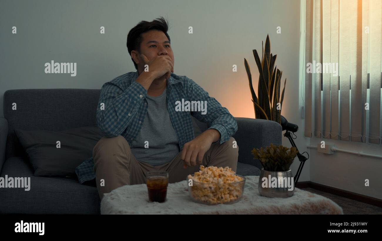 Asian men sit and win their favorite teams broadcasting live football ...