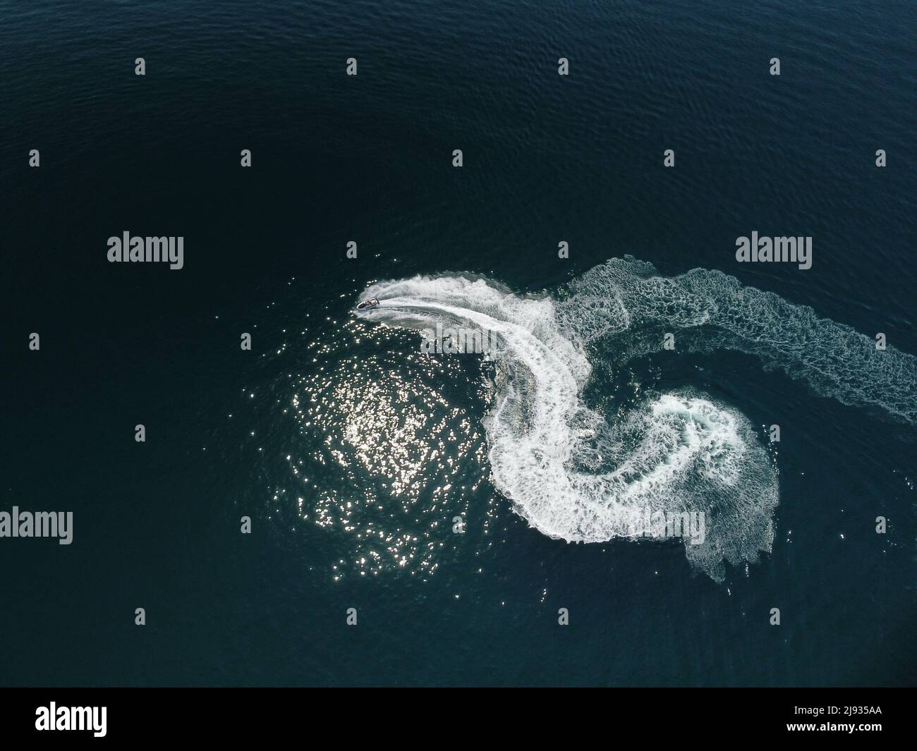 Aerial top down view of water foam trace with nice deep blue shade of ...