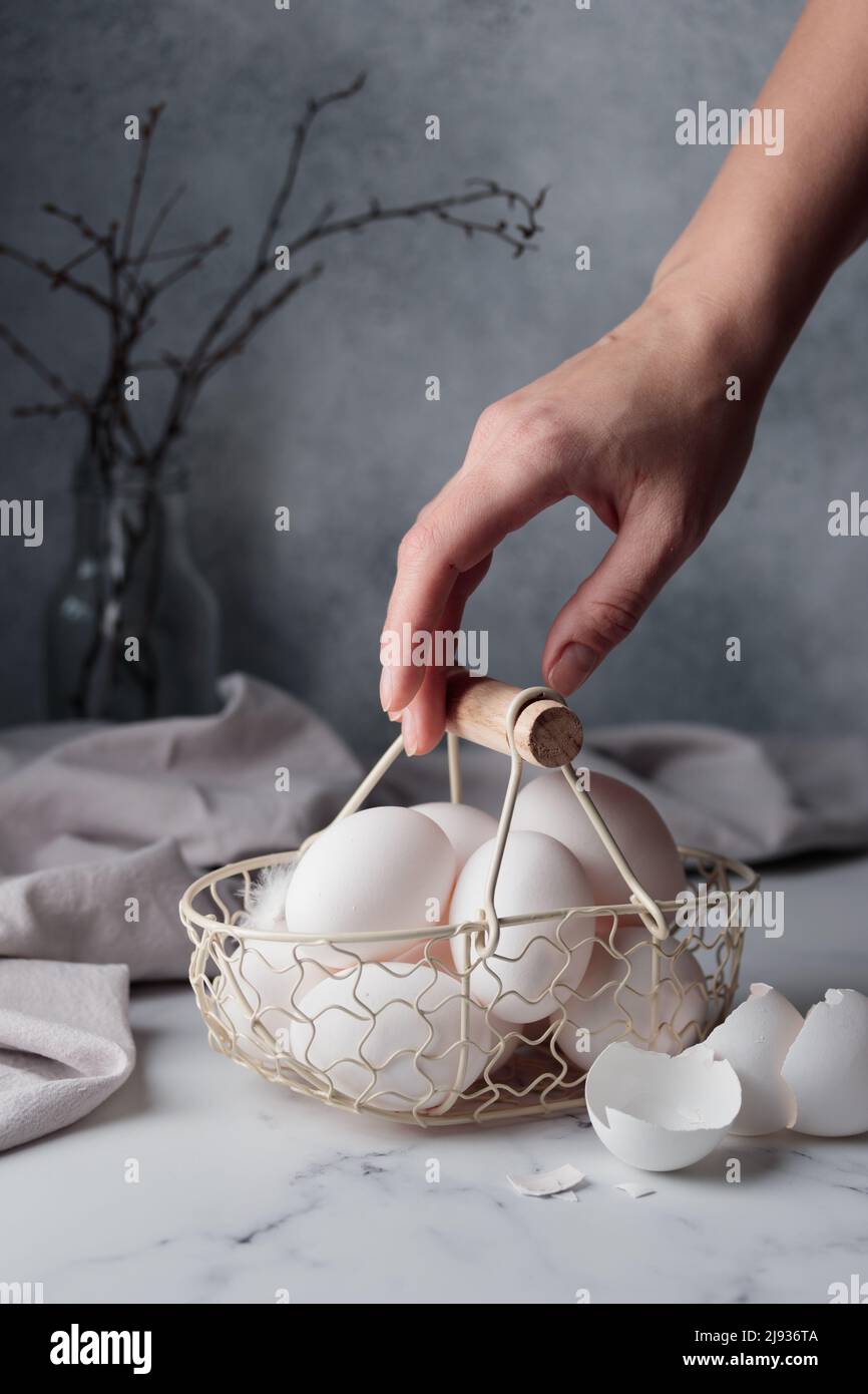 Spring time, easter holidays, white eggs in a basket gray background ...