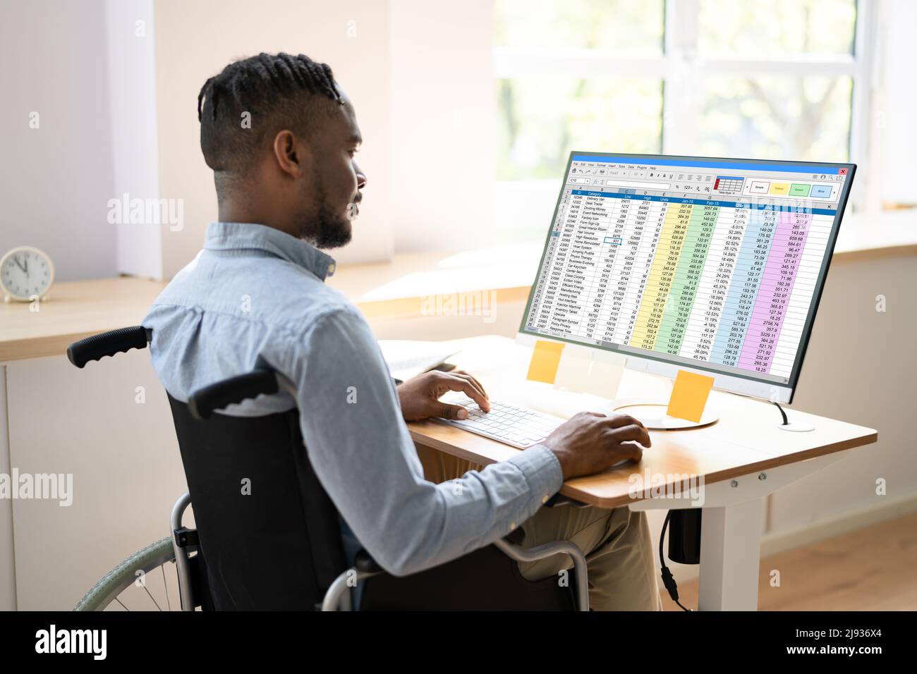 Medical Coding Spreadsheet On PC. African Man In Wheelchair Stock Photo ...