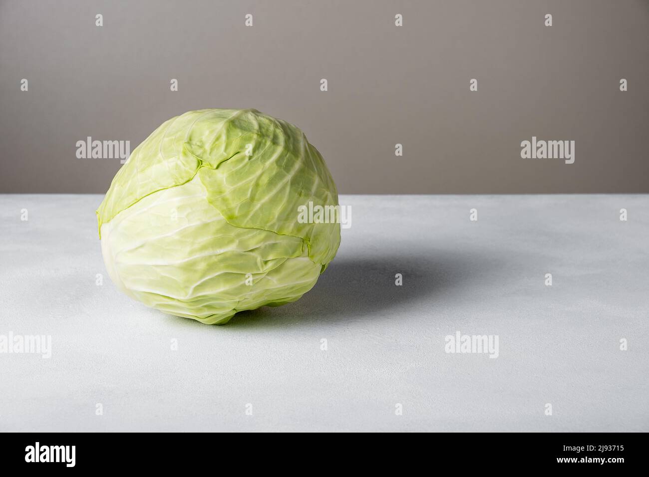 Head of white cabbage lies on surface Stock Photo - Alamy