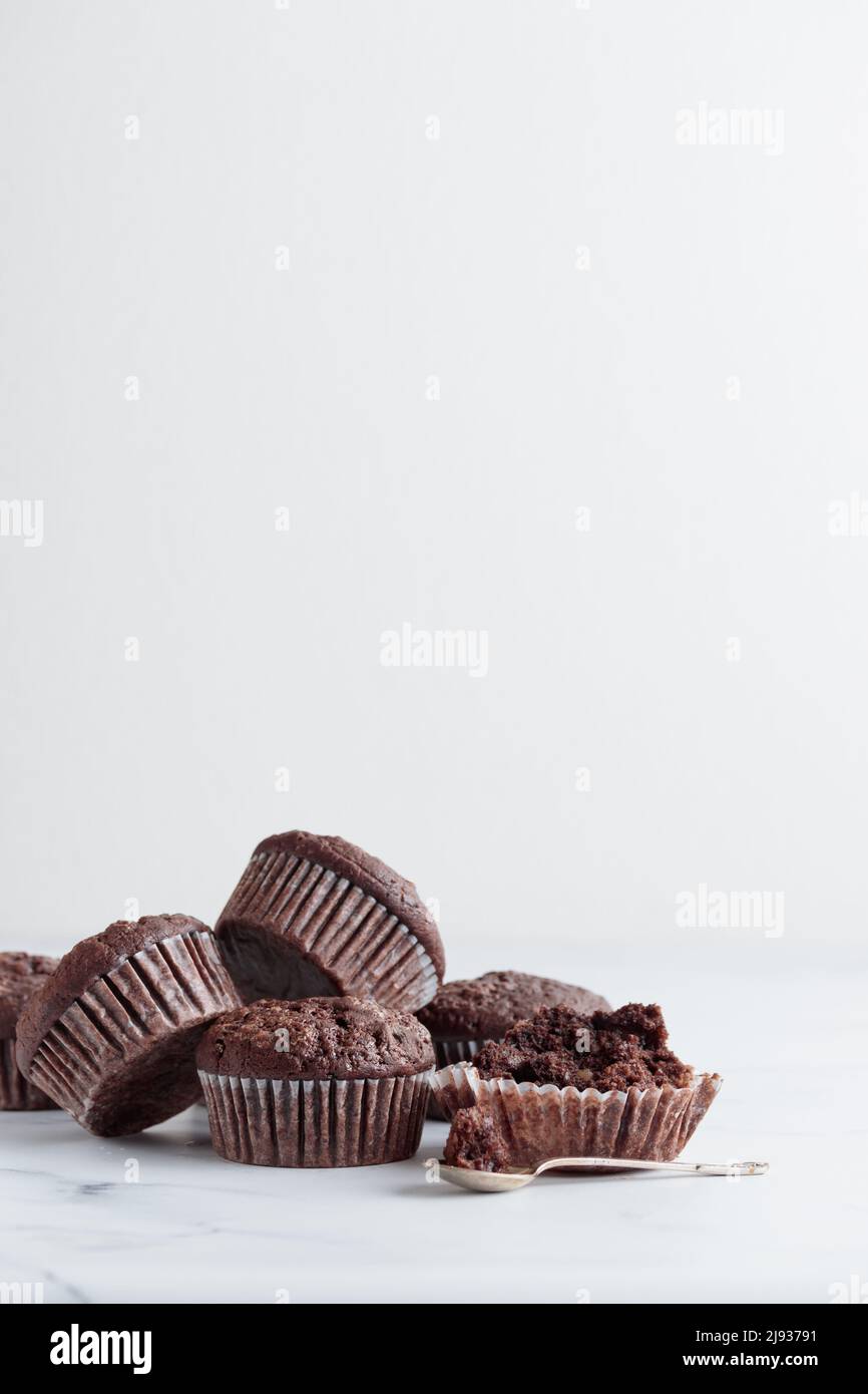 Pile of chocolate muffins on a white background Stock Photo - Alamy