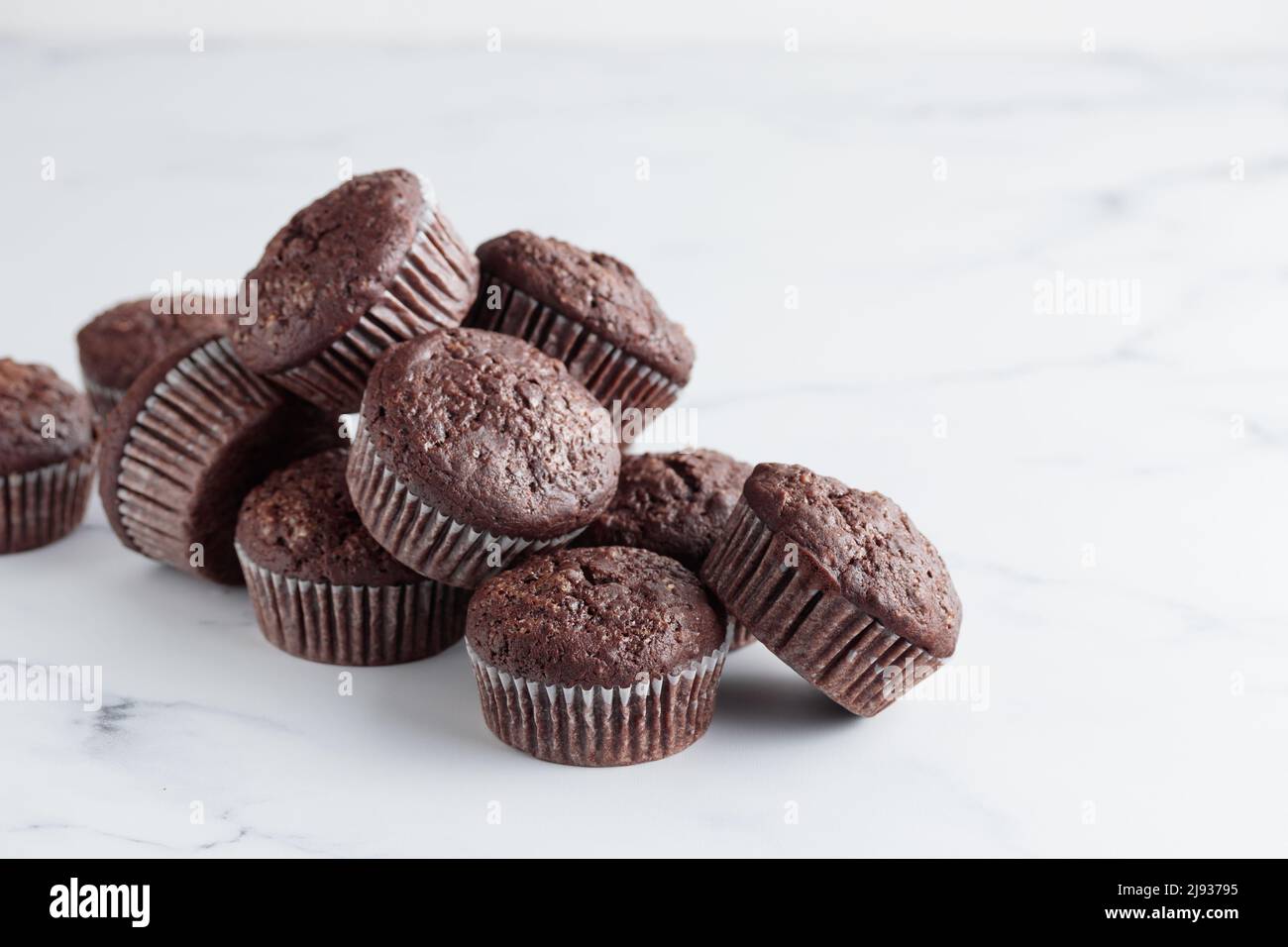 Pile of chocolate muffins on a white background Stock Photo - Alamy