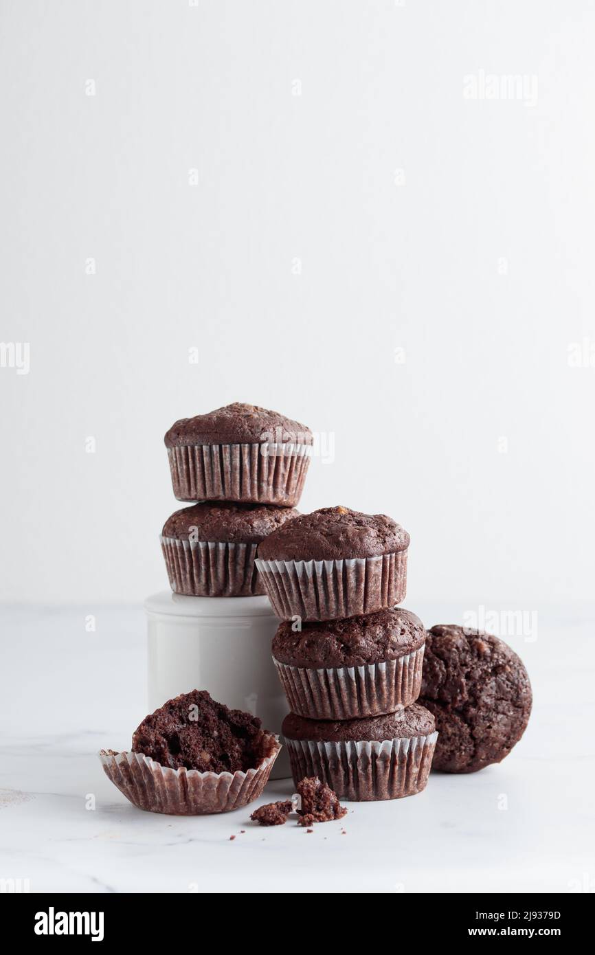 Pile of chocolate muffins on a white background Stock Photo - Alamy