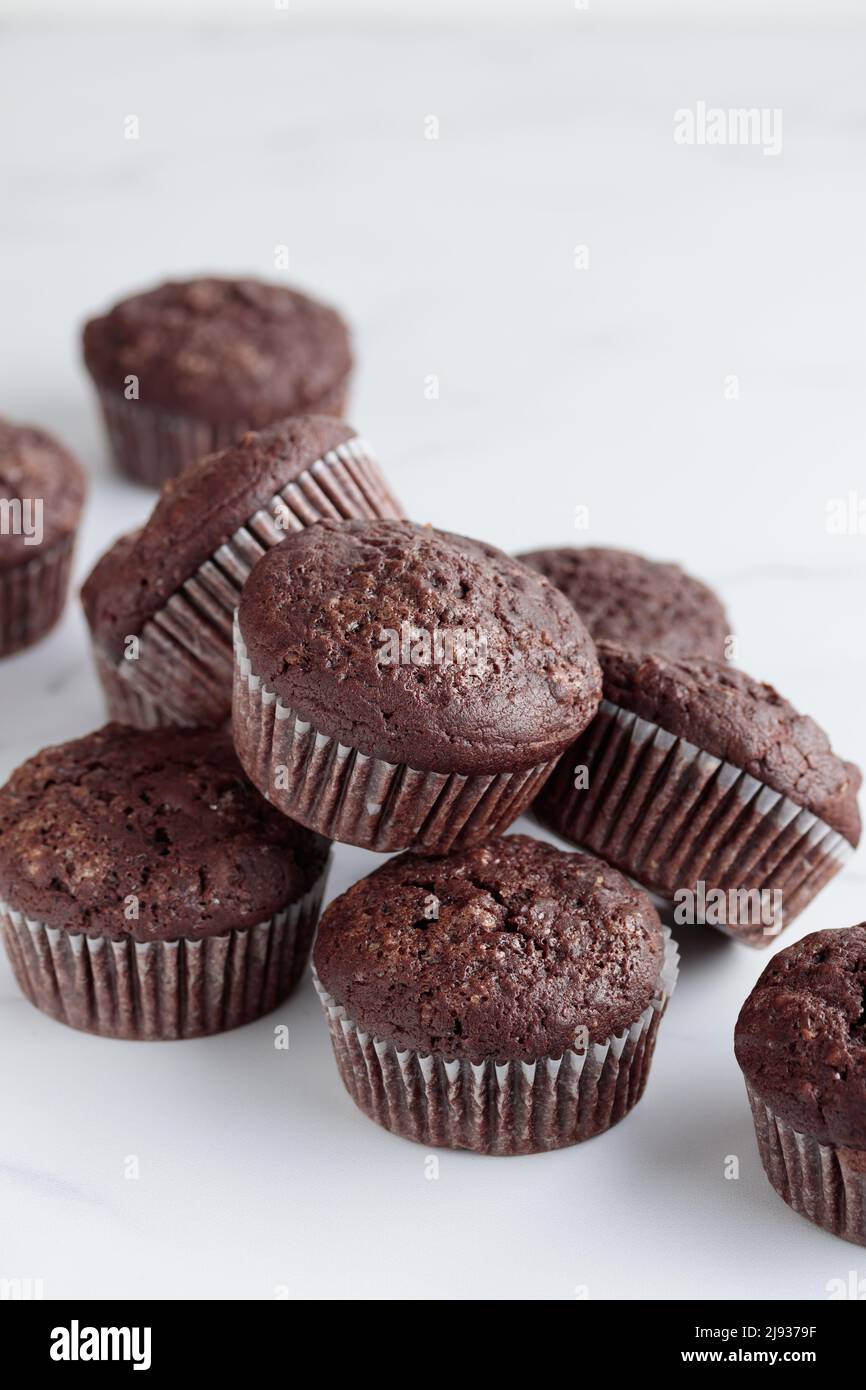 Pile of chocolate muffins on a white background Stock Photo - Alamy