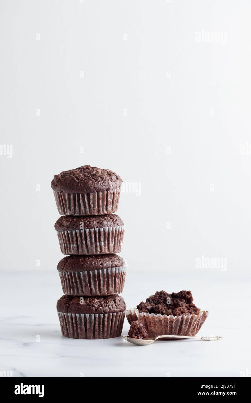 The stack of chocolate muffins on a white background Stock Photo - Alamy