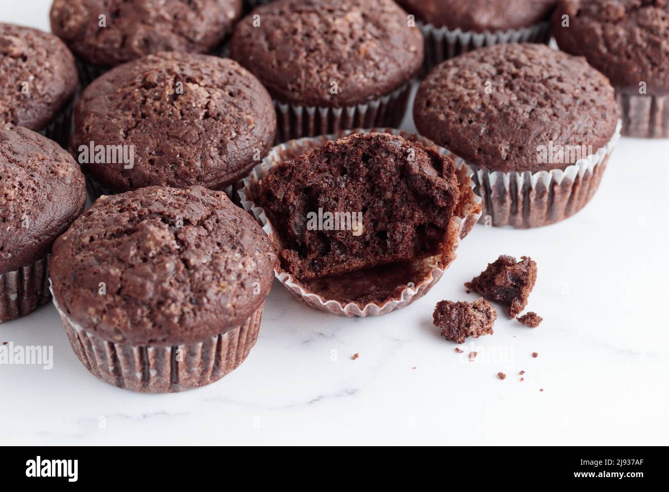 Pile of chocolate muffins on a white background Stock Photo - Alamy