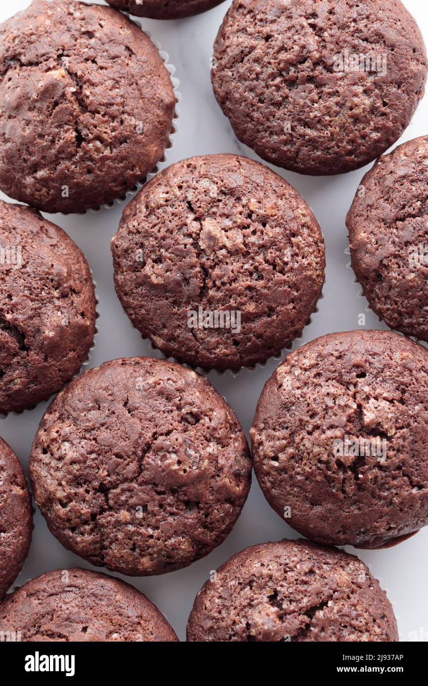 Pile of chocolate muffins on a white background Stock Photo - Alamy