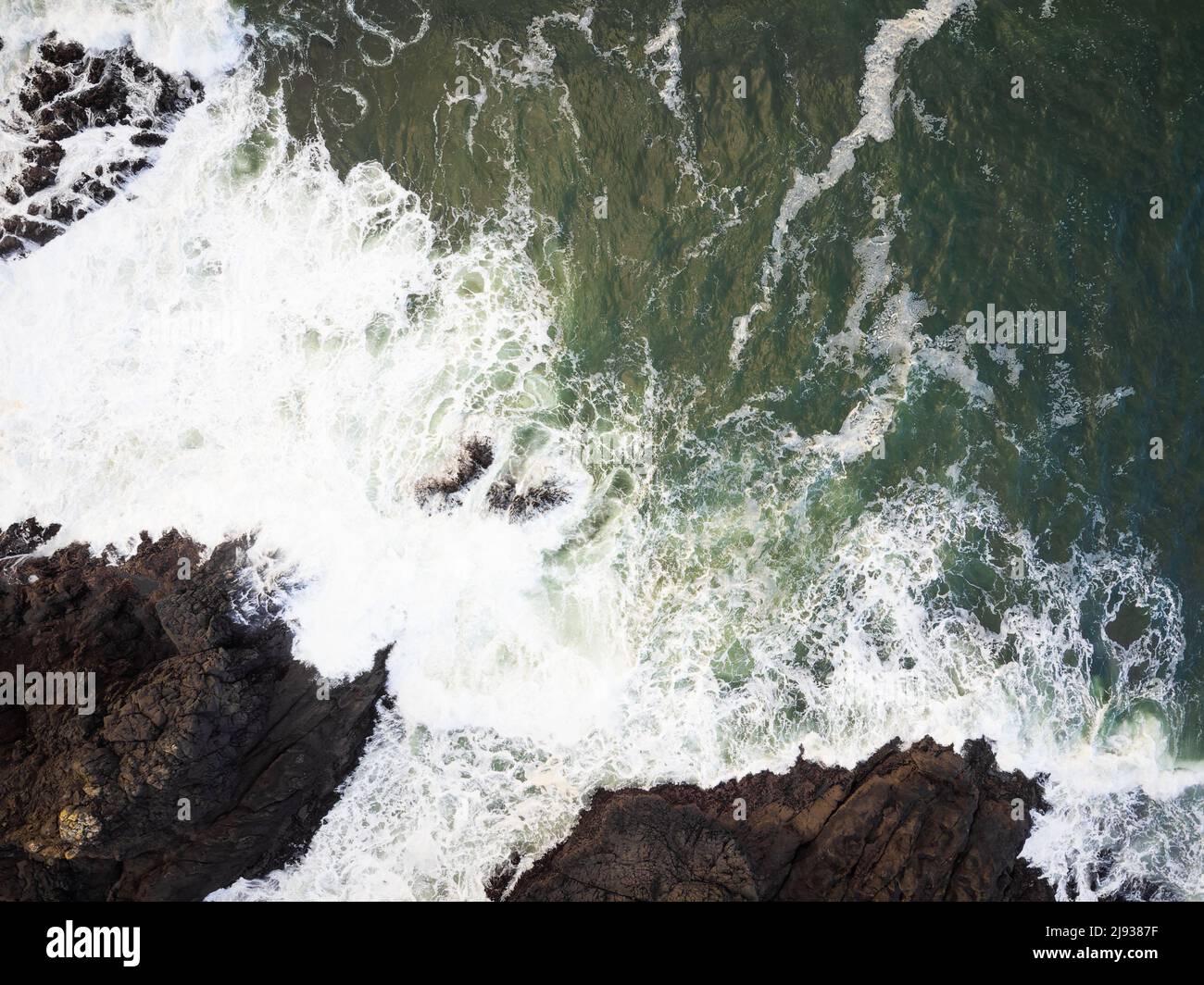 Shot from the air. Storm in the ocean. White foamy waves crash against ...
