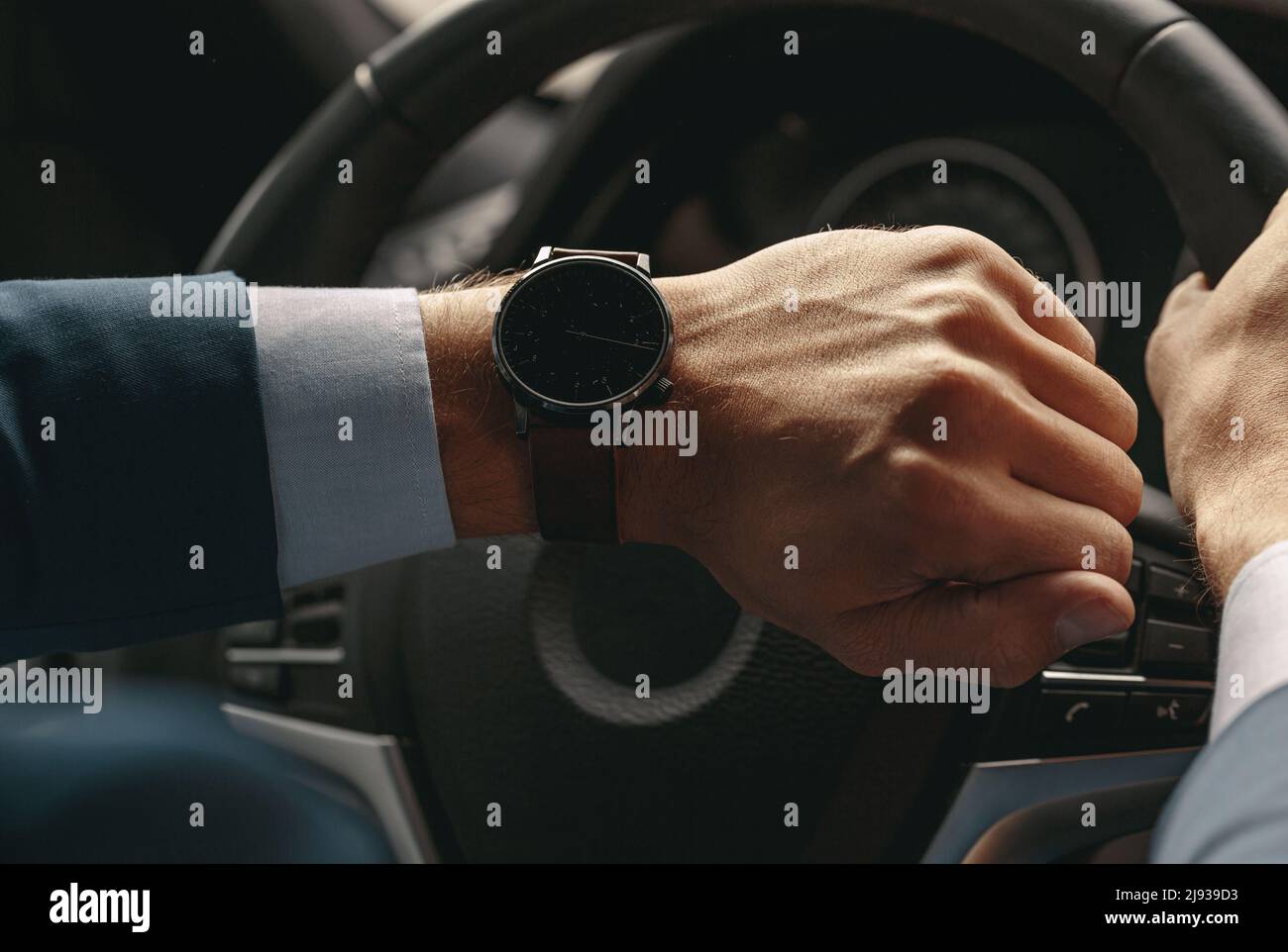 Punctual business man is driving a car Stock Photo - Alamy