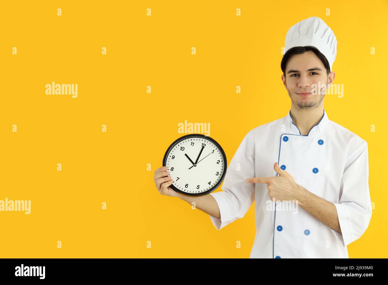 Concept of cooking, young man chef on yellow background Stock Photo - Alamy