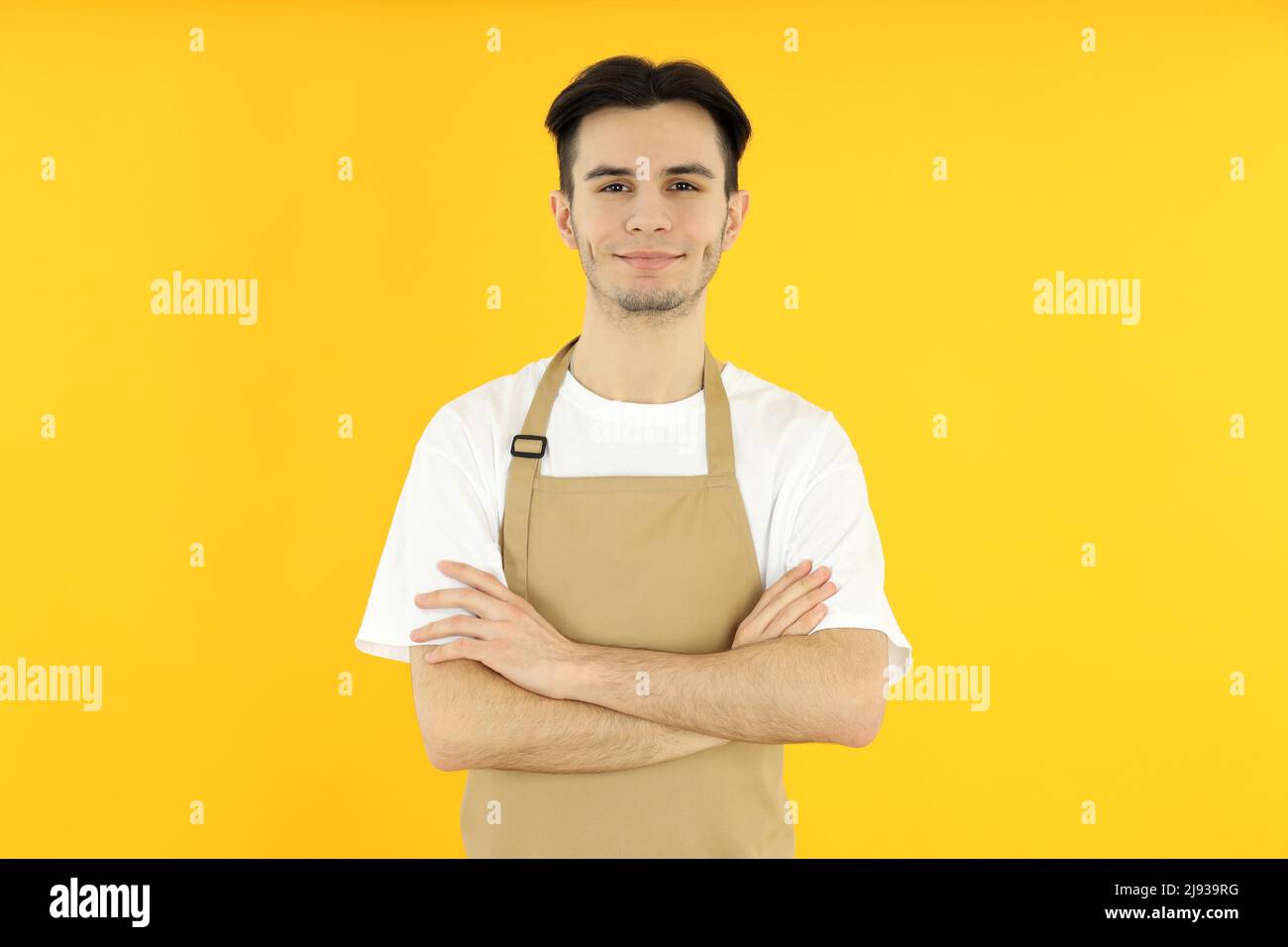 Concept of cooking, young man chef on yellow background Stock Photo - Alamy