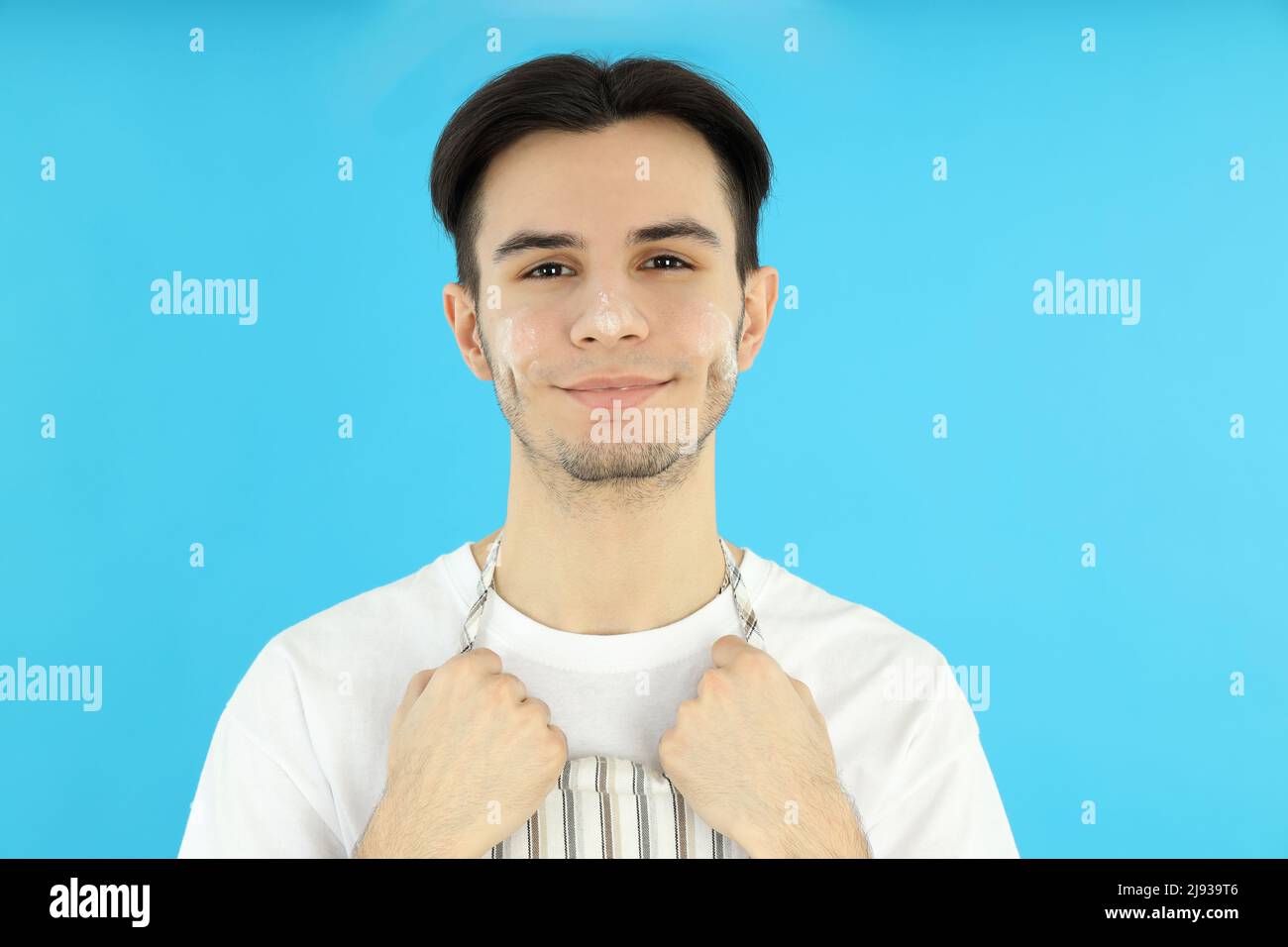 Concept of cooking, young man chef on blue background Stock Photo - Alamy