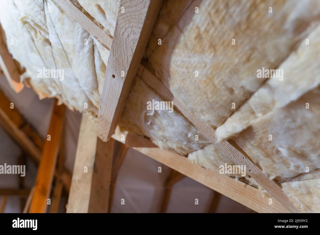 The roof is insulated with yellow glass wool. Insulation hemming with ...